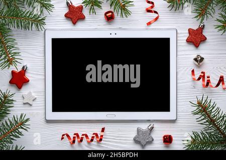 tablet and Christmas tree top view on light grey wooden background. New ...