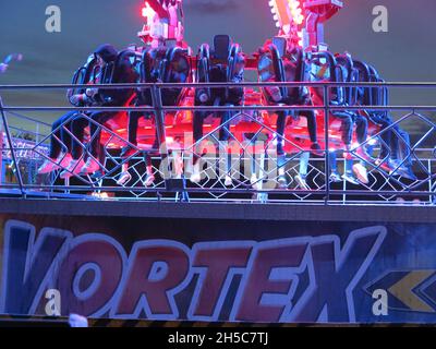 Bonfire Night 2021: illuminated fun fair rides including a swinging vortex ride, with crowds of ...