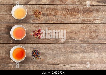 Collection of different teas in cups with tea leaves Stock Photo - Alamy