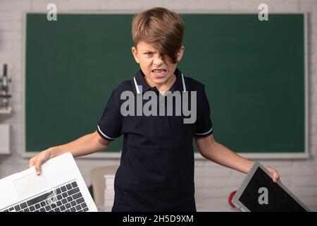 Excited school kid broken laptop. Angry school girl in opposition ...