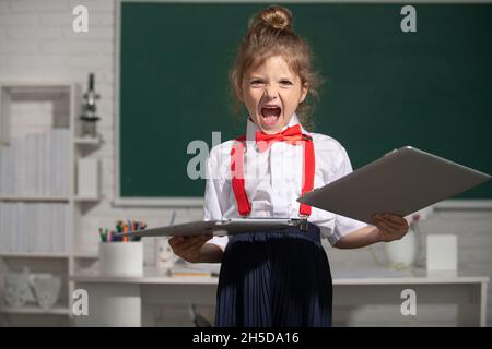Bad angry school girl vs distance education. Sad kid broken online ...