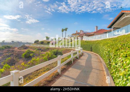 Concrete trail with white wooden railings at Southern California. Path ...