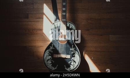black and white guitar illuminated by sun through a window - guitar on ...