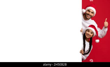 Arab Couple In Santa Hats Making Announcement With Loudspeaker Over Red ...