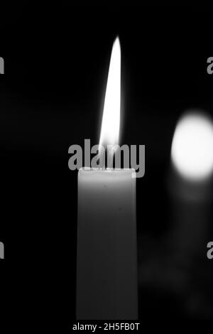 Grayscale shot of a burning candle Stock Photo - Alamy