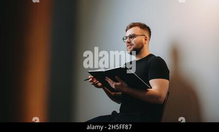 Boy wearing eyeglasses holding pen at home Stock Photo - Alamy
