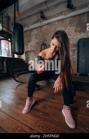 Young woman pumps up the muscles by one arm lifting dumbbell Stock ...