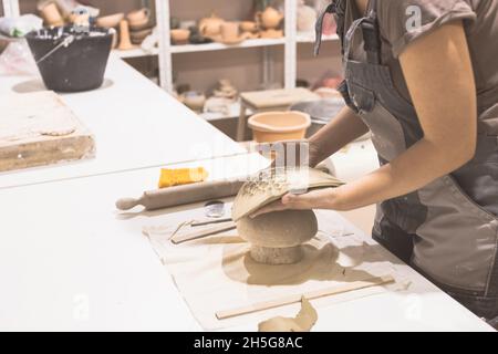 Ceramic artist prepare clay for mold at table. Creative handmade craft ...