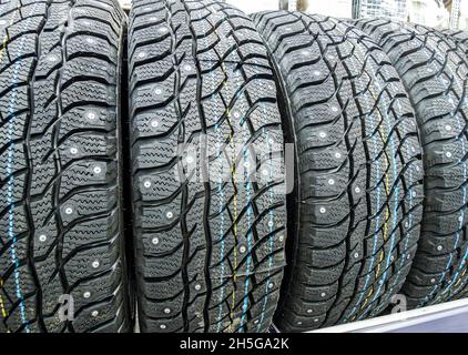 Winter vehicle tires stacked up for sale in the chain hypermarket. New ...