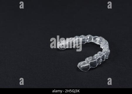 Invisalign braces or invisible retainer on pink background. High ...