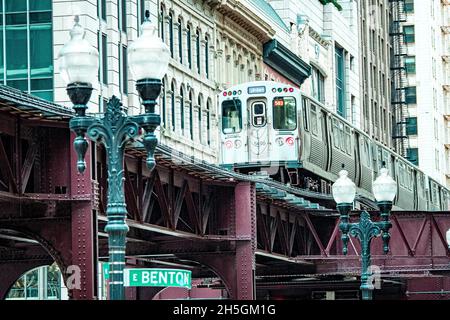 Moving Train on elevated tracks within buildings at the Loop, Glass and ...