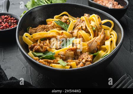 Pasta with rosemary rabbit stew set, in frying cast iron pan or pot, on ...