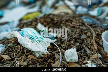 Used face mask discard in household garbage. Medical waste disposal ...
