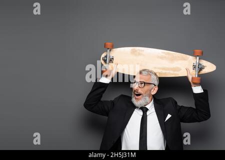 amazed handsome mature man hold book or notebook for education and ...