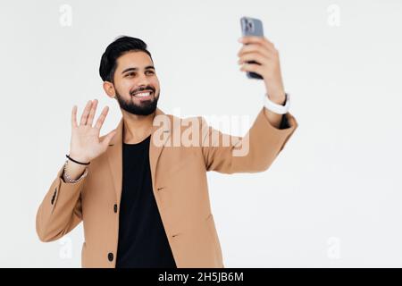 Cheerful guy talking about internet promo, smiling amazed and pointing ...