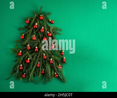 Frame made of paper Christmas balls, snow, fir cone and anise on green ...