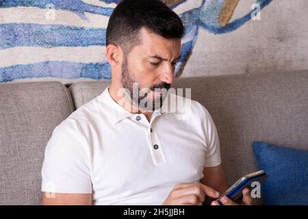 Businessman interacting and consulting a mobile in an office ...