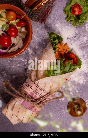 Fresh fried chicken roll with fresh tomatos, salad, cheese and onions ...