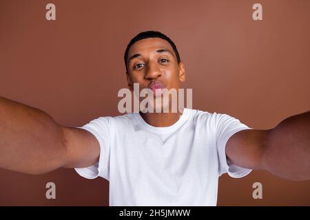 Photo of positive groomed man wear stylish clothes speak telephone arm ...