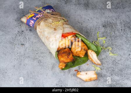 Fresh chicken tikka roll with fresh tomatos, salad, cheese and onions ...