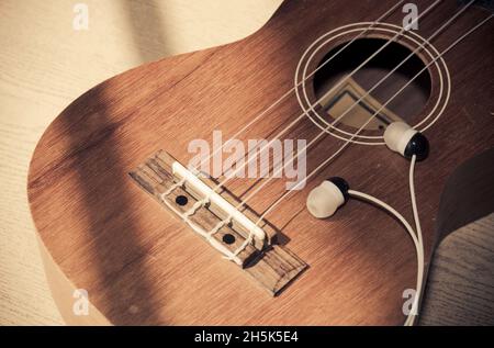 Vintage ukulele on wooden background Stock Photo - Alamy