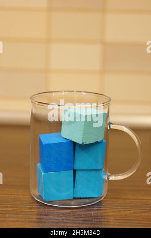 Bathing cubes in a glass cup; background with a copy space Stock Photo ...