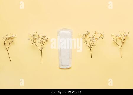 Menstrual pad and flowers on yellow background Stock Photo - Alamy
