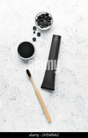 Toothpaste tube, bamboo toothbrush, bowls with activated charcoal tooth ...