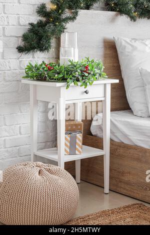 Beautiful mistletoe wreath with candles on mantelpiece in room Stock ...