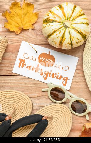Sunglasses, pumpkin, flip flops and paper card with text HAPPY ...