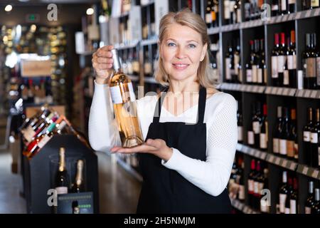 Female vintner recommending wine Stock Photo - Alamy