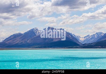 Lake Pukaki. Lake with turquoise water among the snow-capped peaks ...