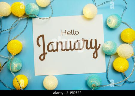 Hello December text message with LED cotton ball decoration on wooden ...