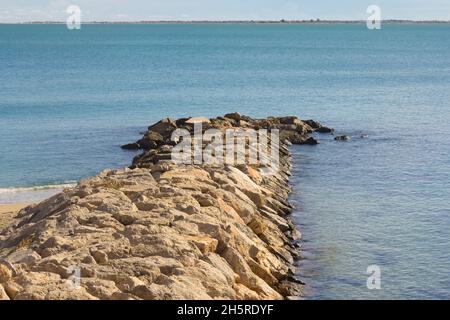 Rock breakwater in the sea; controlling waves Stock Photo - Alamy