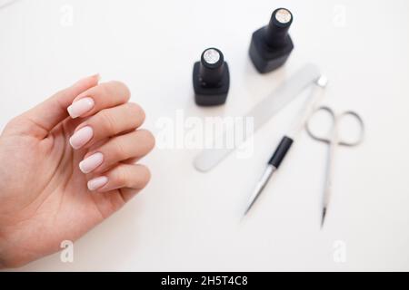 Manicure or pedicure supplies tools and hand on table Stock Photo - Alamy