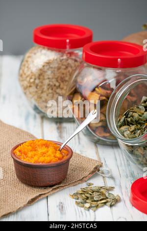 Sunflower milk in a glass, raw seeds, wooden background. Dairy free ...