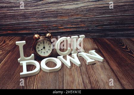 Lockdown alphabet letters with alarm clock on wooden background Stock ...