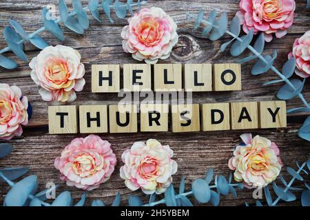 Hello Thursday alphabet letter and flower decorate on wooden background ...