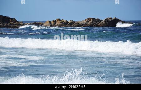 Pacific Ocean waves crushing at rocks and splashing water around in ...