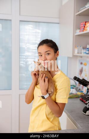 young Asian woman doctor hold clipboard smile at modern medical clinic ...