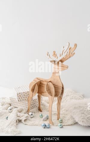 Wooden reindeer with Christmas gift boxes on beige background Stock ...