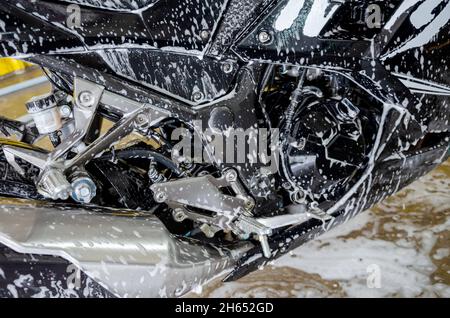 Wash motorcycle with foam Stock Photo - Alamy