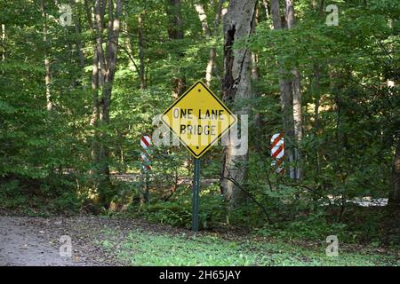 Yellow warning sign warning of a one Lane Bridge ahead Stock Photo - Alamy