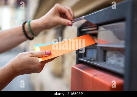 Sending post letter service concept. Young smiling man cartoon character standing putting ...