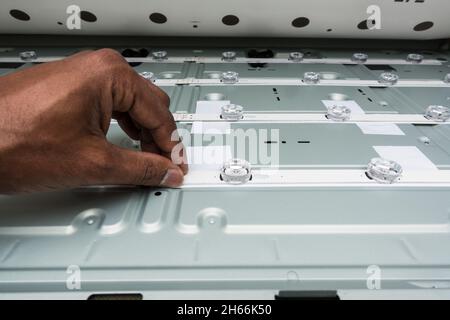Fixing broken LED lights of a LCD display Television screen Stock Photo ...