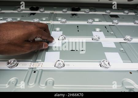 Fixing broken LED lights of a LCD display Television screen Stock Photo ...