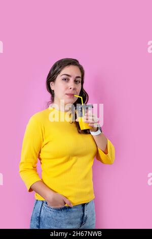 Young brunette woman standing over white brick wall thinking looking ...