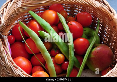 Basket of tomatoes, runner beans, apples Stock Photo - Alamy