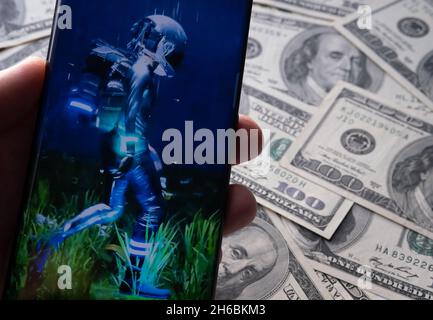 Beeple's 'HUMAN ONE' NFT stop frame image seen on smartphone and dollar ...