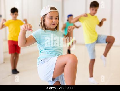 Tween girl breakdancer posing during group dance class Stock Photo - Alamy